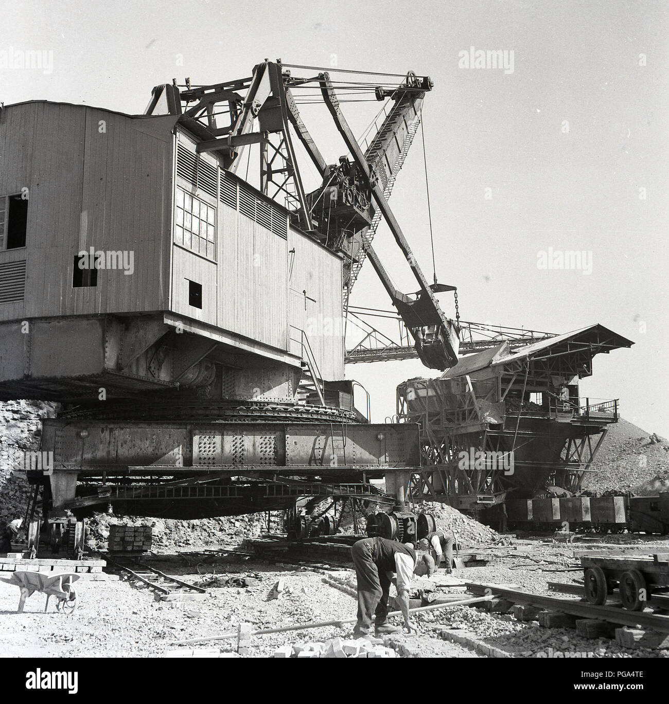 1950s, historical, a giant industrial excavator in a large quarry or ...