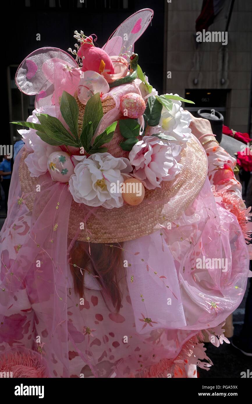 A woman wearing an elaborate Easter bonnet, complete with colored eggs ...