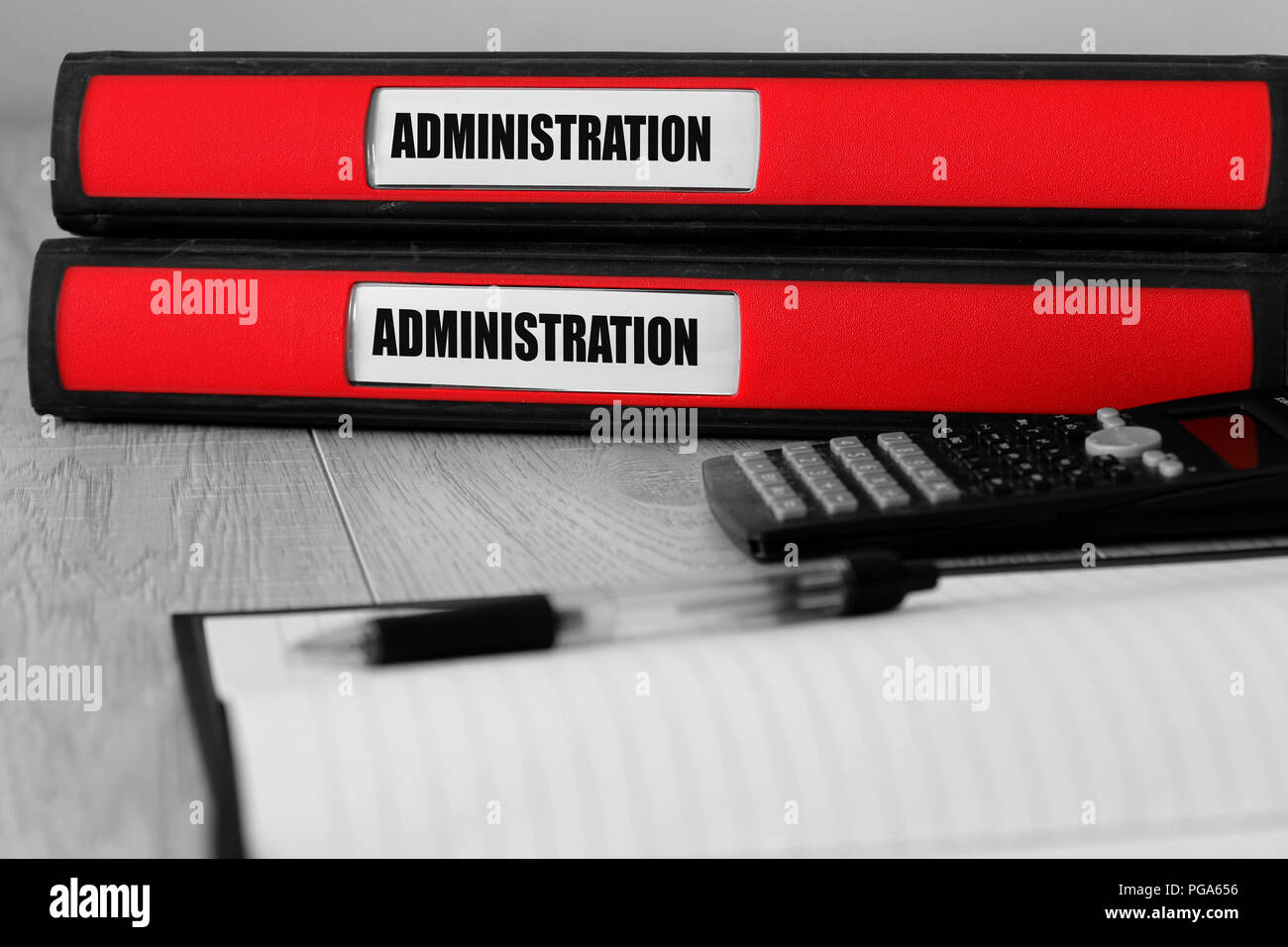 Red folders with administration written on the label on a desk with ...