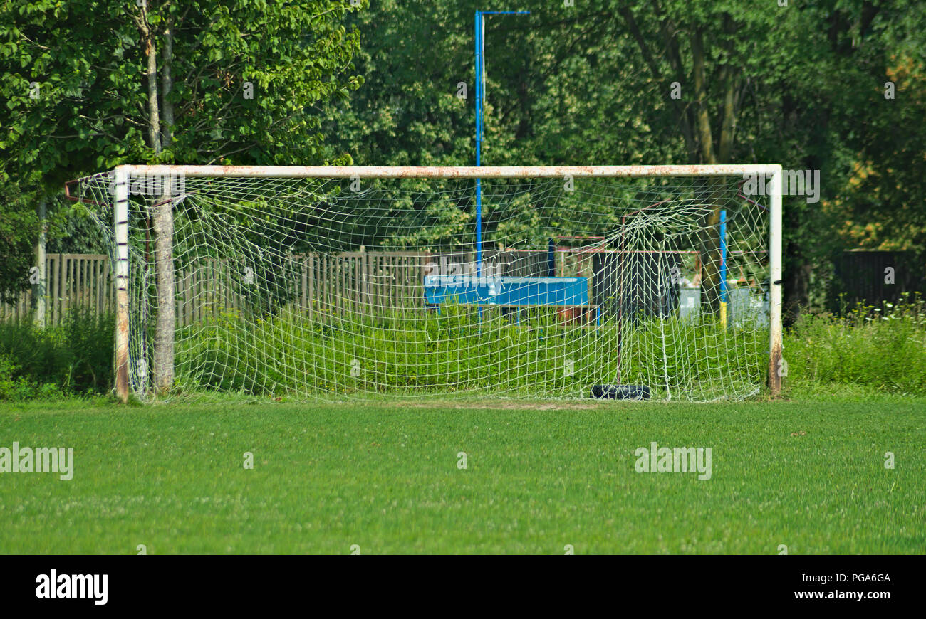 Rustic metal goal gate on football field Stock Photo - Alamy