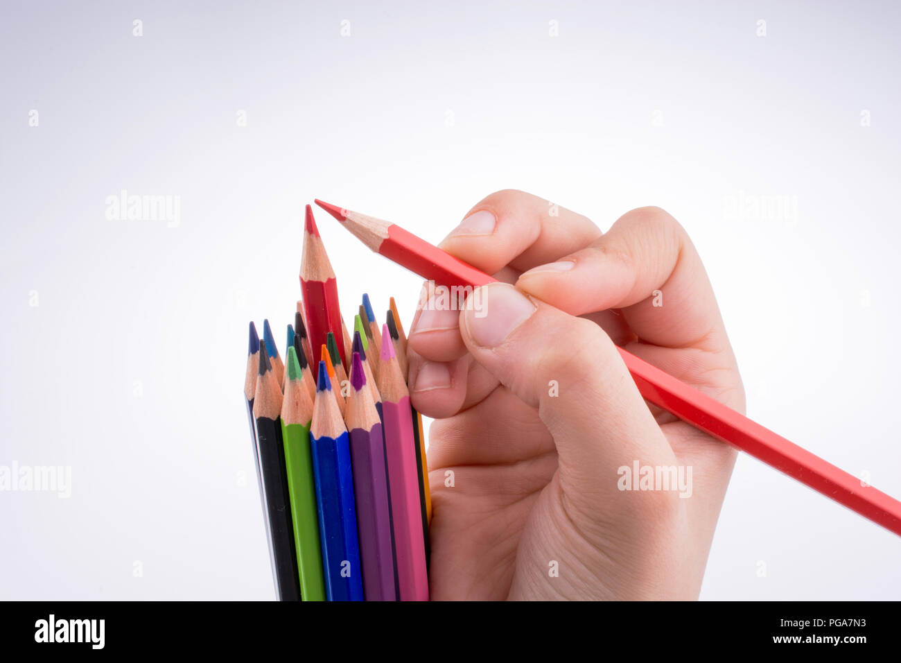 Hand holding color pencils on a white background Stock Photo - Alamy