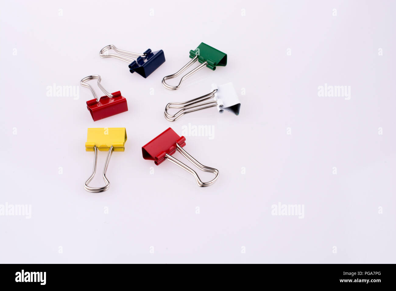 Colored paper clips on a white background Stock Photo - Alamy