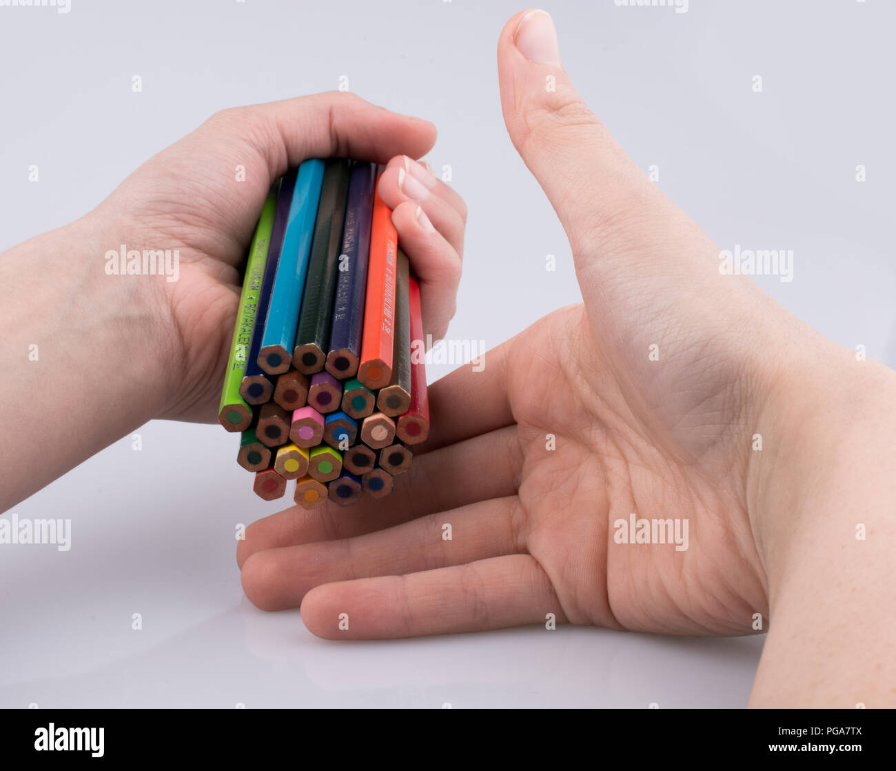 Hand holdin color pencils on a white background Stock Photo - Alamy