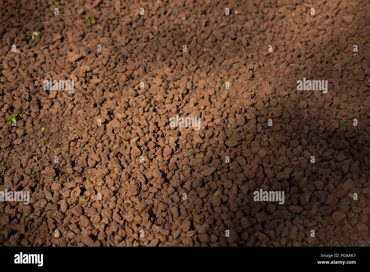 Brown lumpy soil in a shady light as a background Stock Photo - Alamy