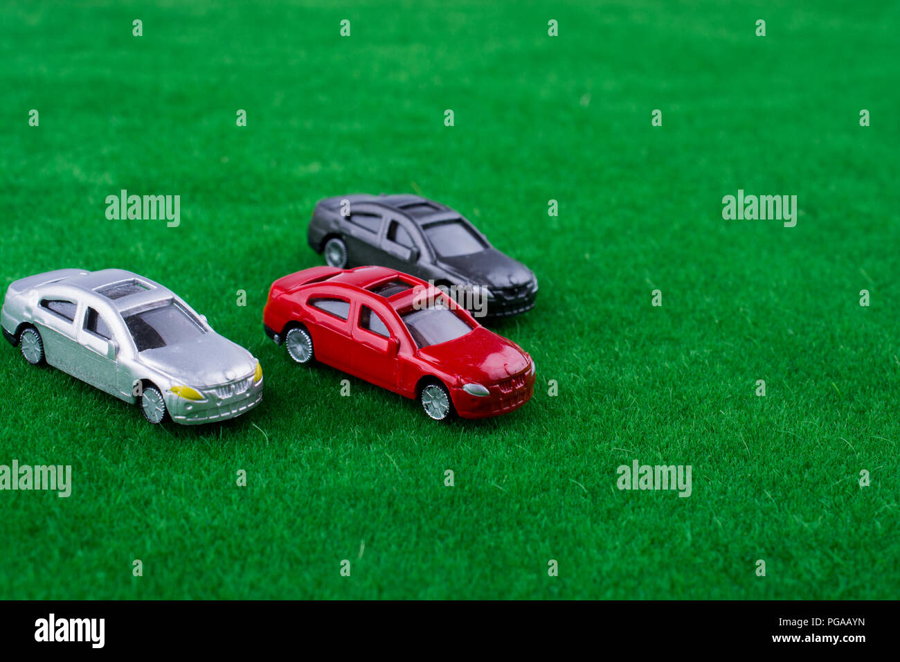 Color cars on green grass Stock Photo - Alamy