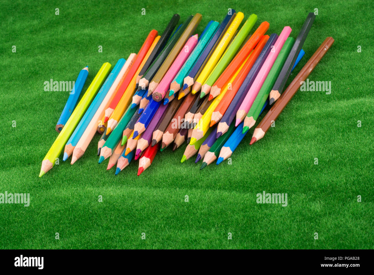 Color pencils scattered on green grass Stock Photo - Alamy