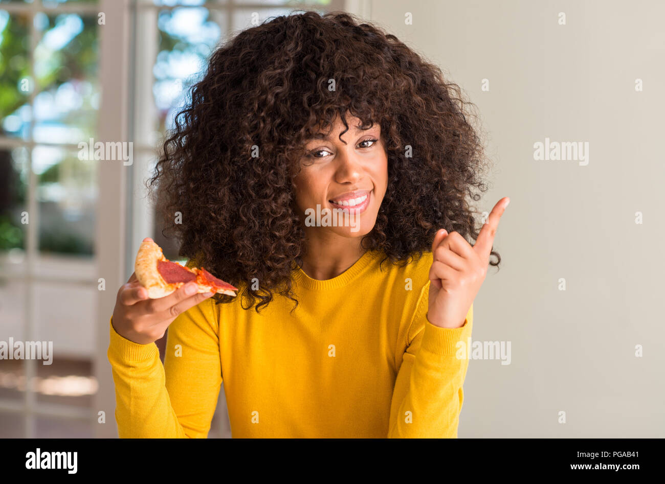 African american woman ready to eat pepperoni pizza slice very happy ...