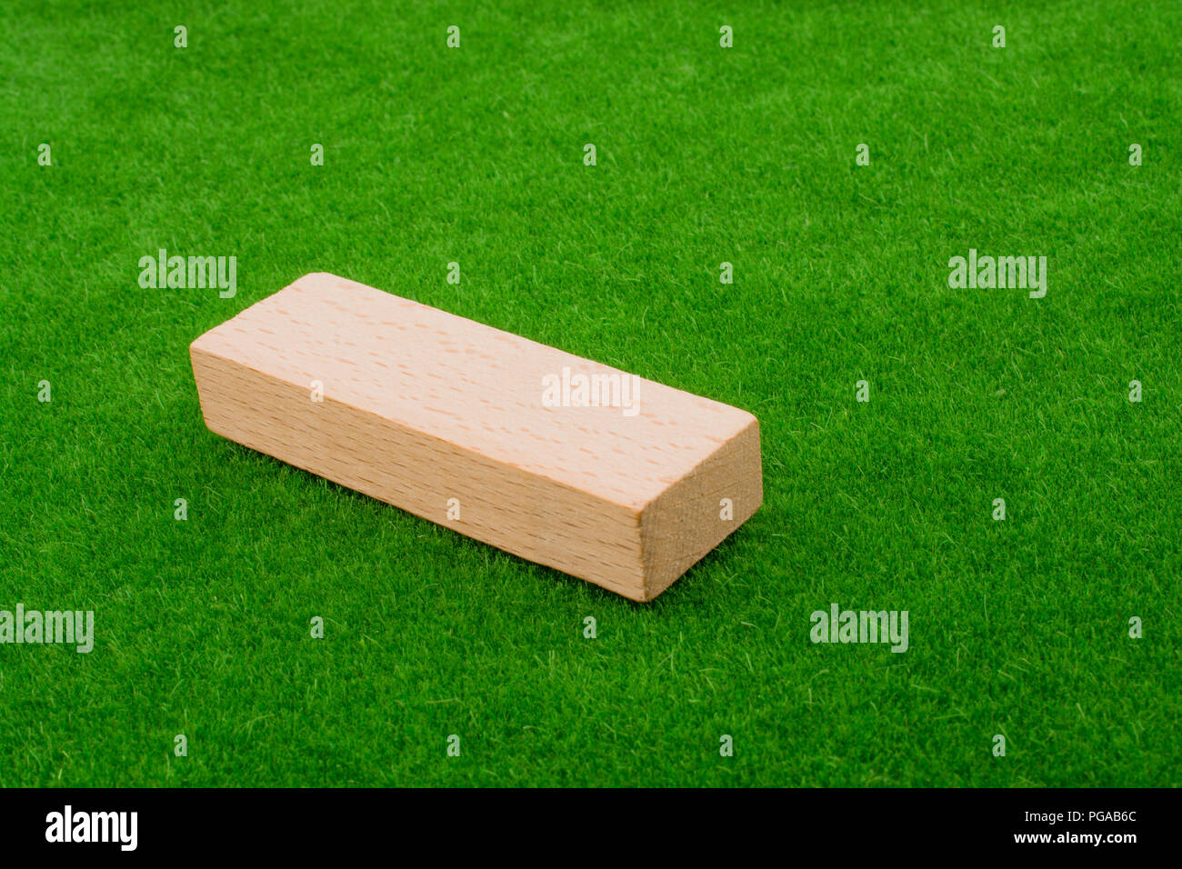 Wooden domino on green grass Stock Photo - Alamy