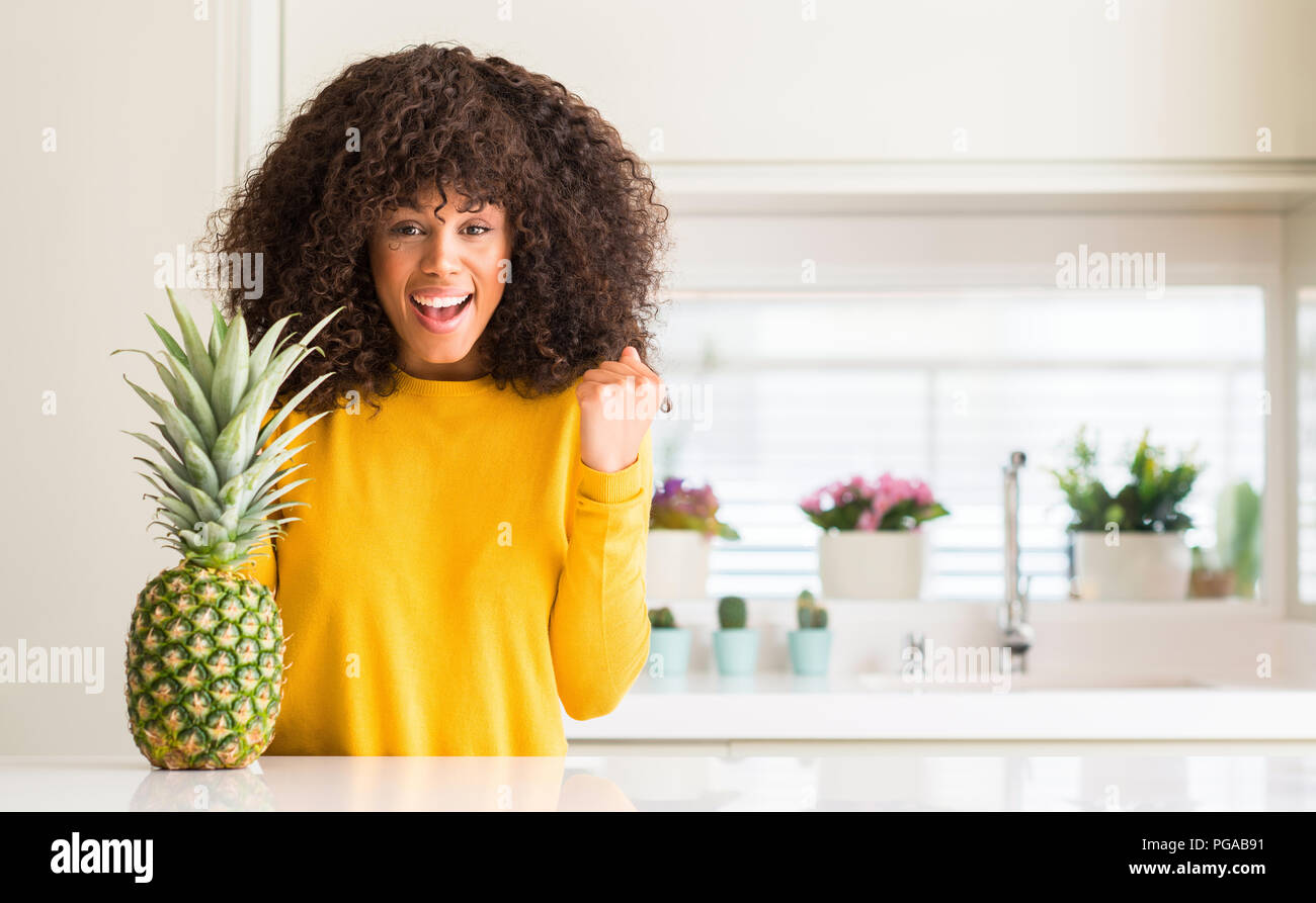 African american woman and pineapple tropical fruit screaming proud and ...