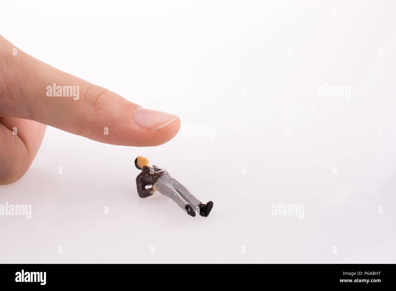 Hand threating to smash human figure on a white background Stock Photo ...