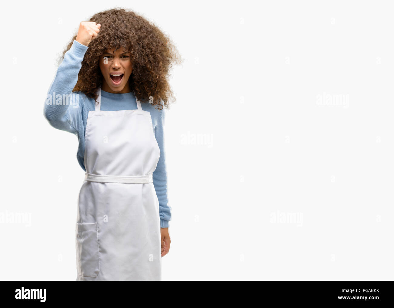African american shop owner woman wearing an apron irritated and angry ...