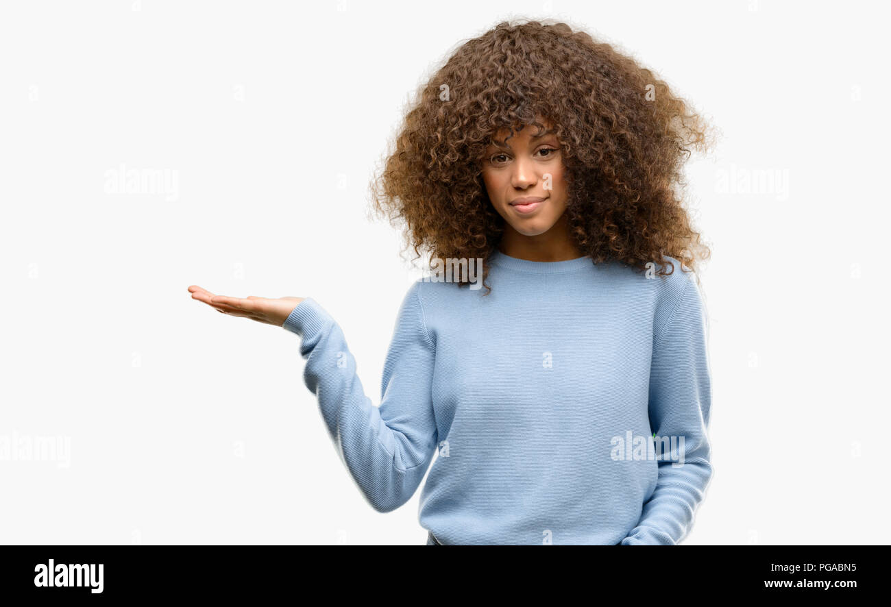 African american woman wearing a sweater smiling cheerful presenting ...