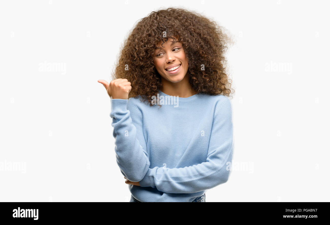African american woman wearing a sweater smiling with happy face ...