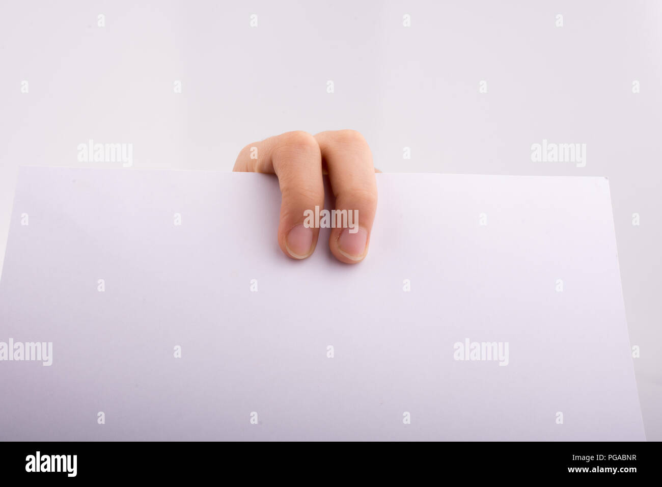 Hand holding a white sheet of paper on a white background Stock Photo ...