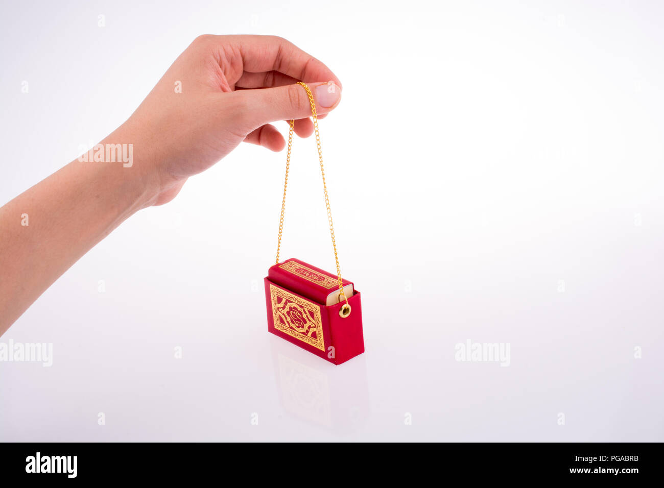 Hand holding The Holy Quran on a white background Stock Photo - Alamy