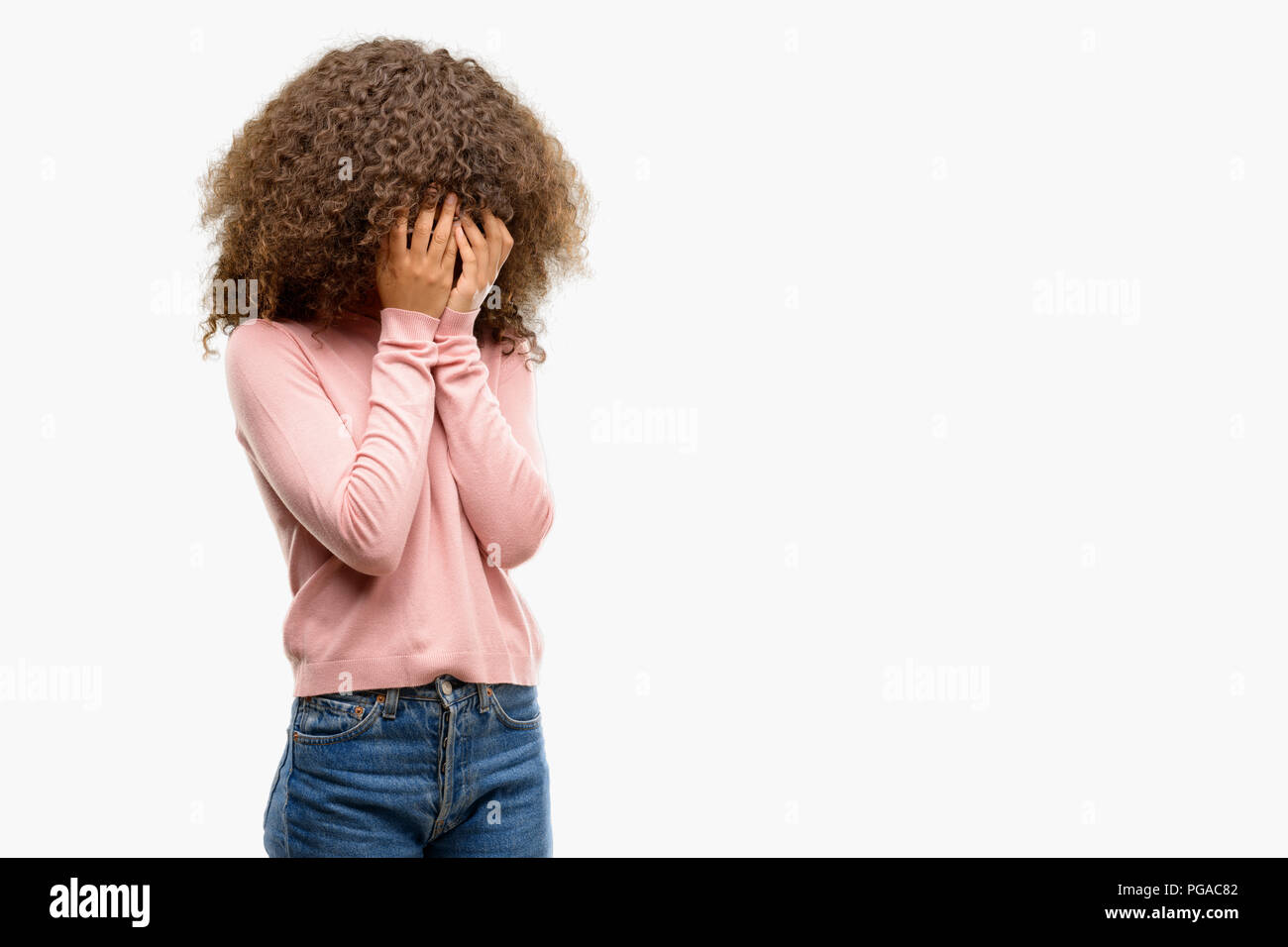 Woman wearing pink sweater jeans Cut Out Stock Images & Pictures - Alamy