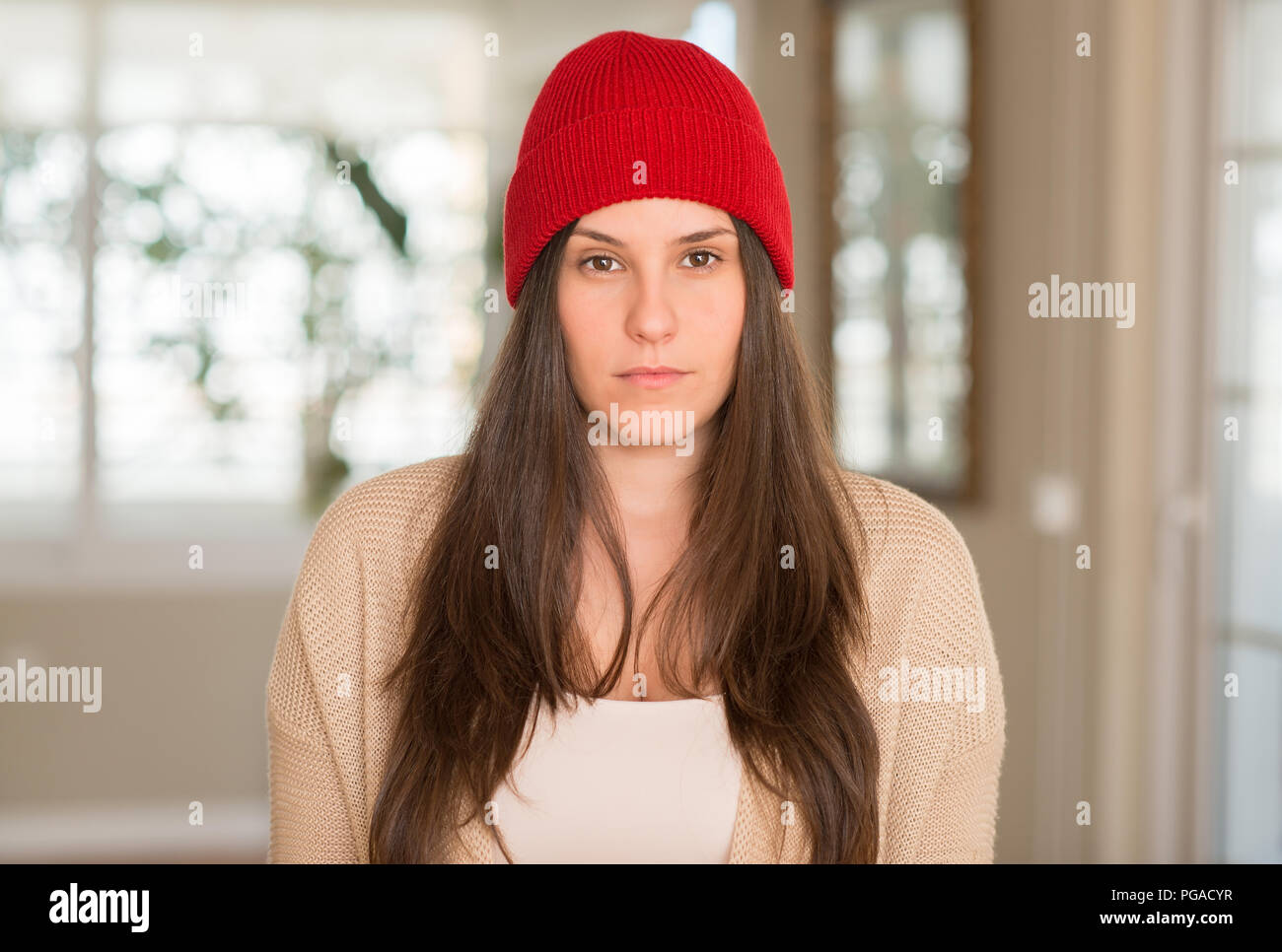Young beautiful woman wearing red cap at home with a confident ...