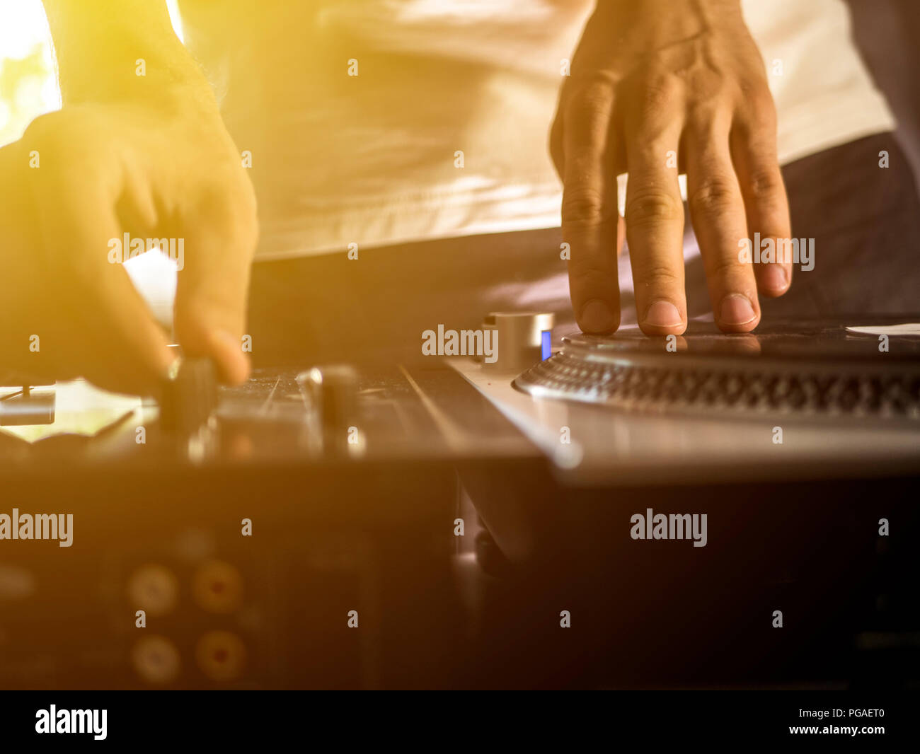 close up young dj playing modern music on professional equipment setup ...
