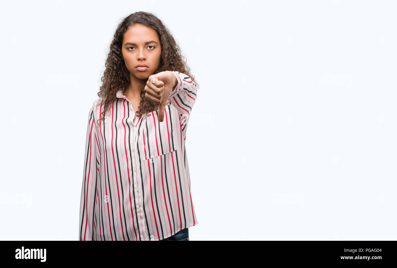 Beautiful young hispanic woman looking unhappy and angry showing ...