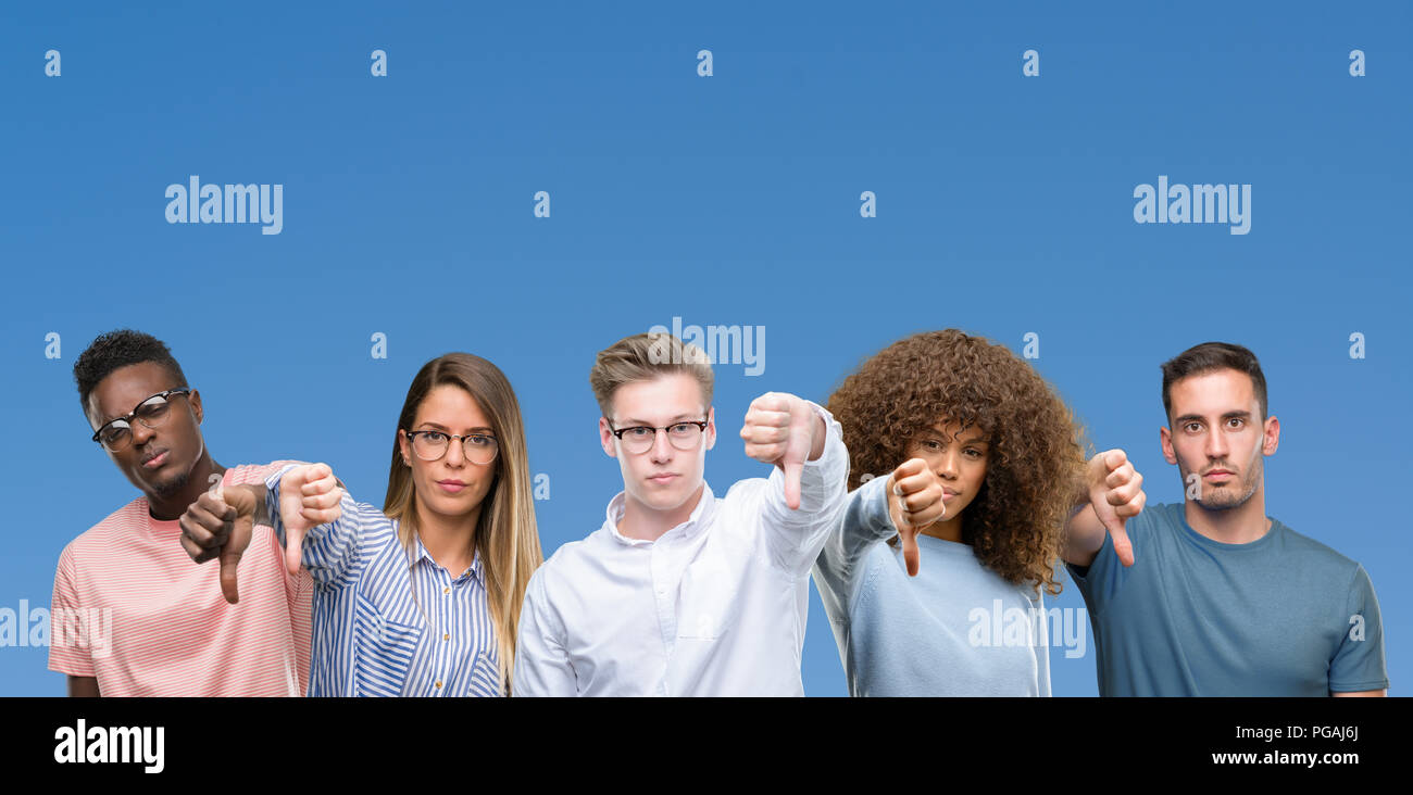 Composition of group of friends over blue blackground looking unhappy ...