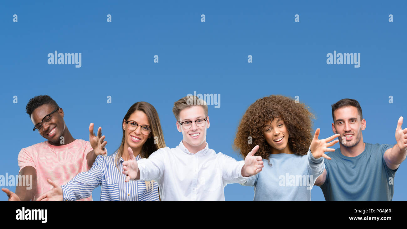 Composition of group of friends over blue blackground looking at the ...