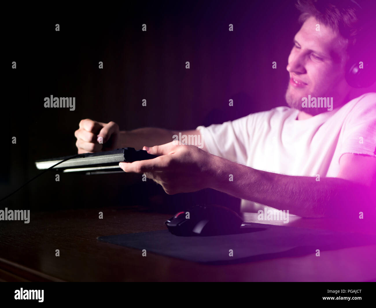 young mad crazy gamer breaking the keyboard playing video games on ...