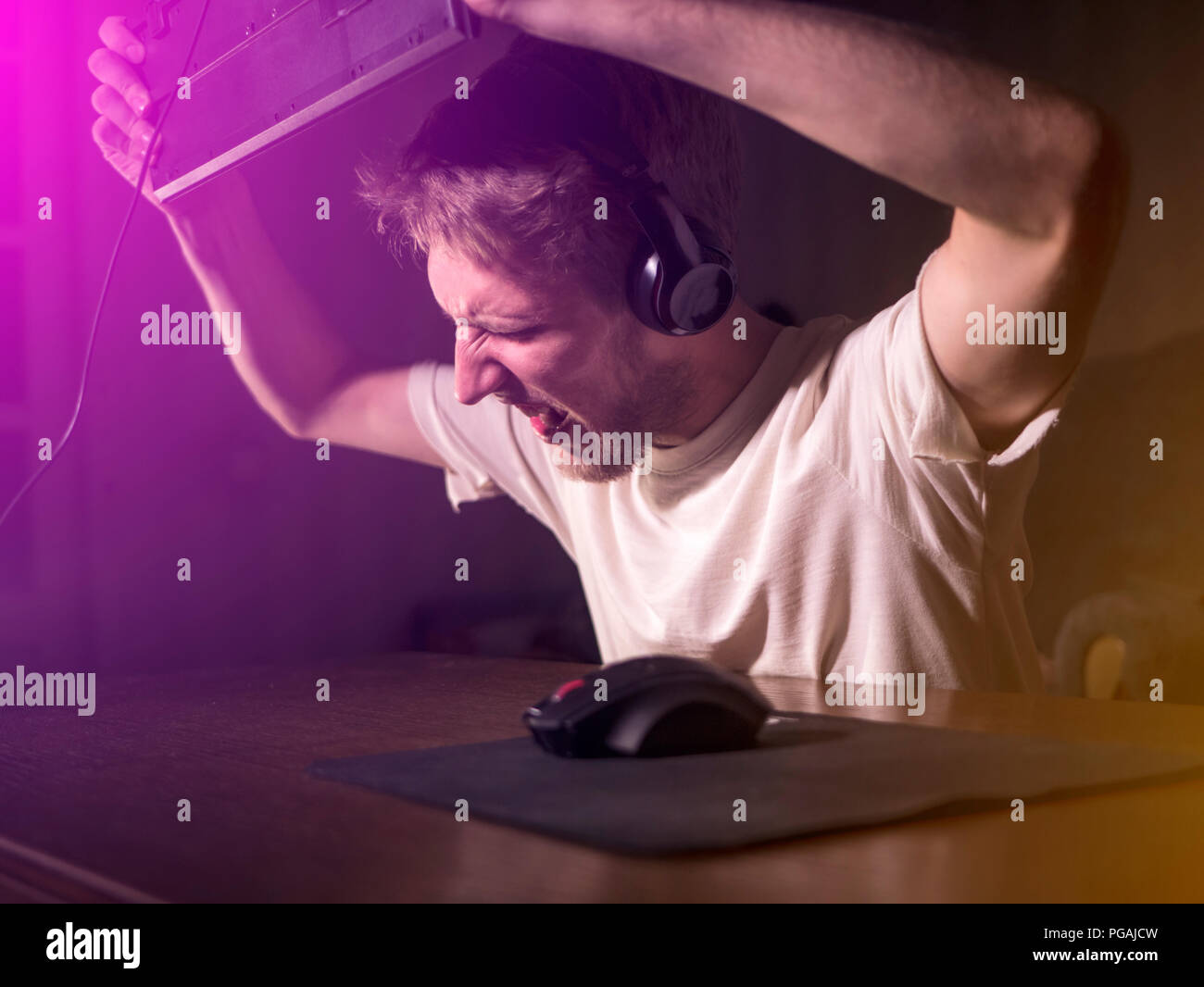 young mad crazy gamer breaking the keyboard playing video games on ...