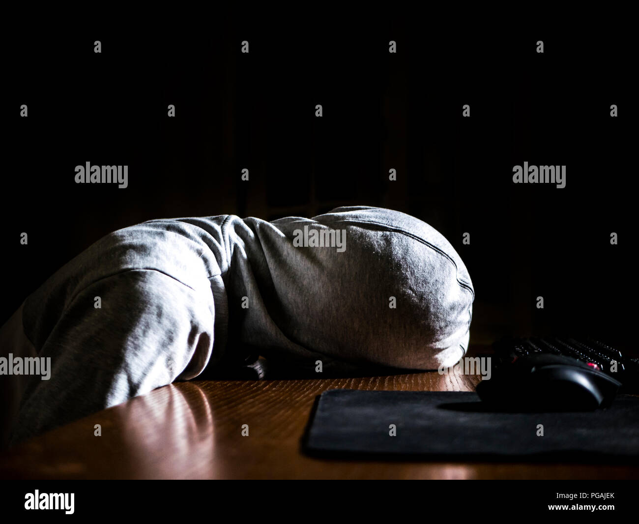 abstract anonymous person in the hood sleeping lying on the table in ...