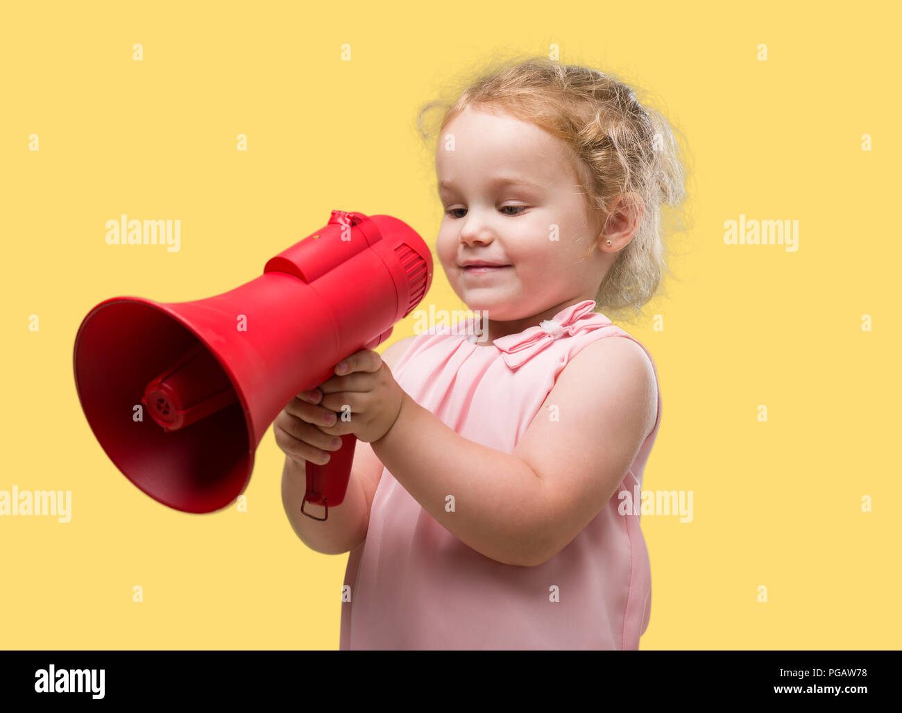 Lovely blonde toddler shouting through megaphone Stock Photo - Alamy