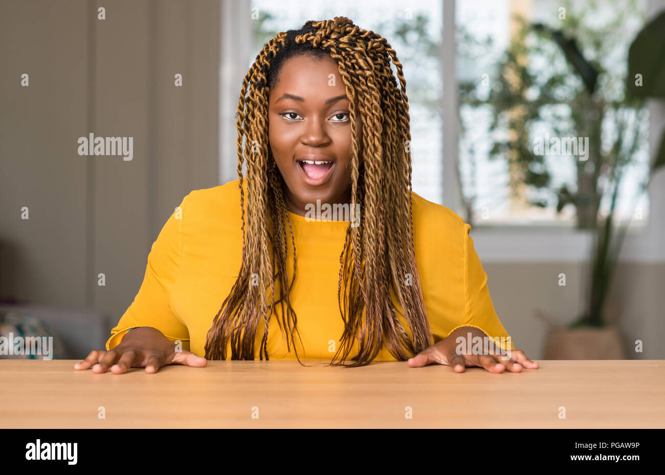 African american woman at home scared in shock with a surprise face ...