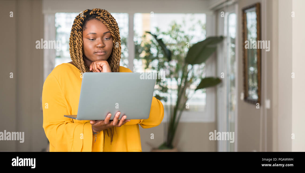 African american woman with laptop serious face thinking about question ...