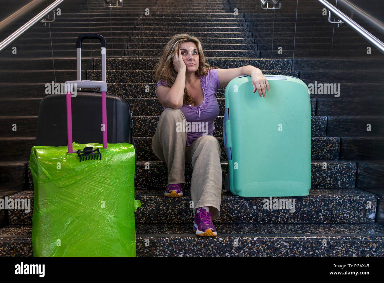 tired tourist traveler waiting sitting on the stairs with baggage at ...