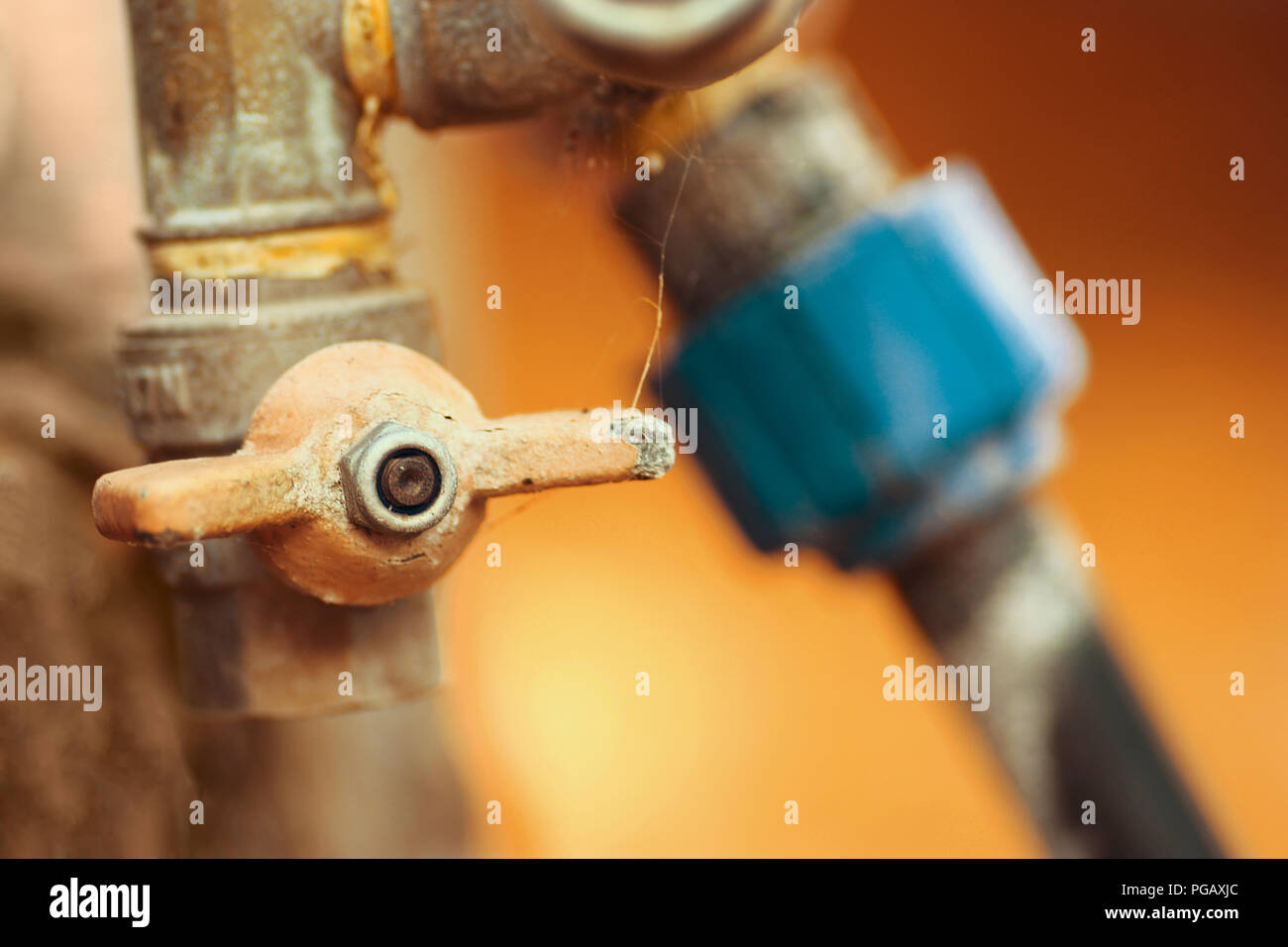 Obsolete water valve and pipe retro color Stock Photo - Alamy