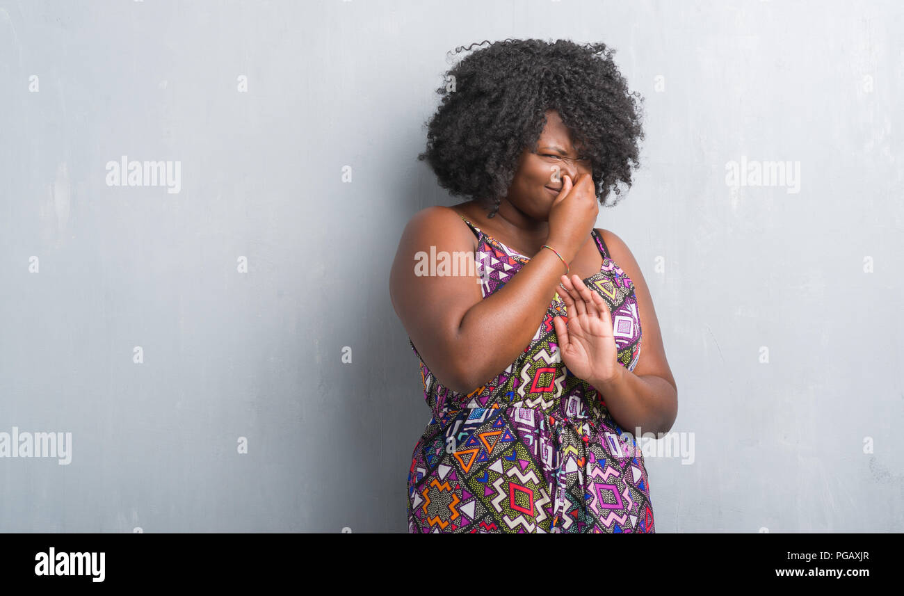 Young african american woman over grey grunge wall wearing colorful ...