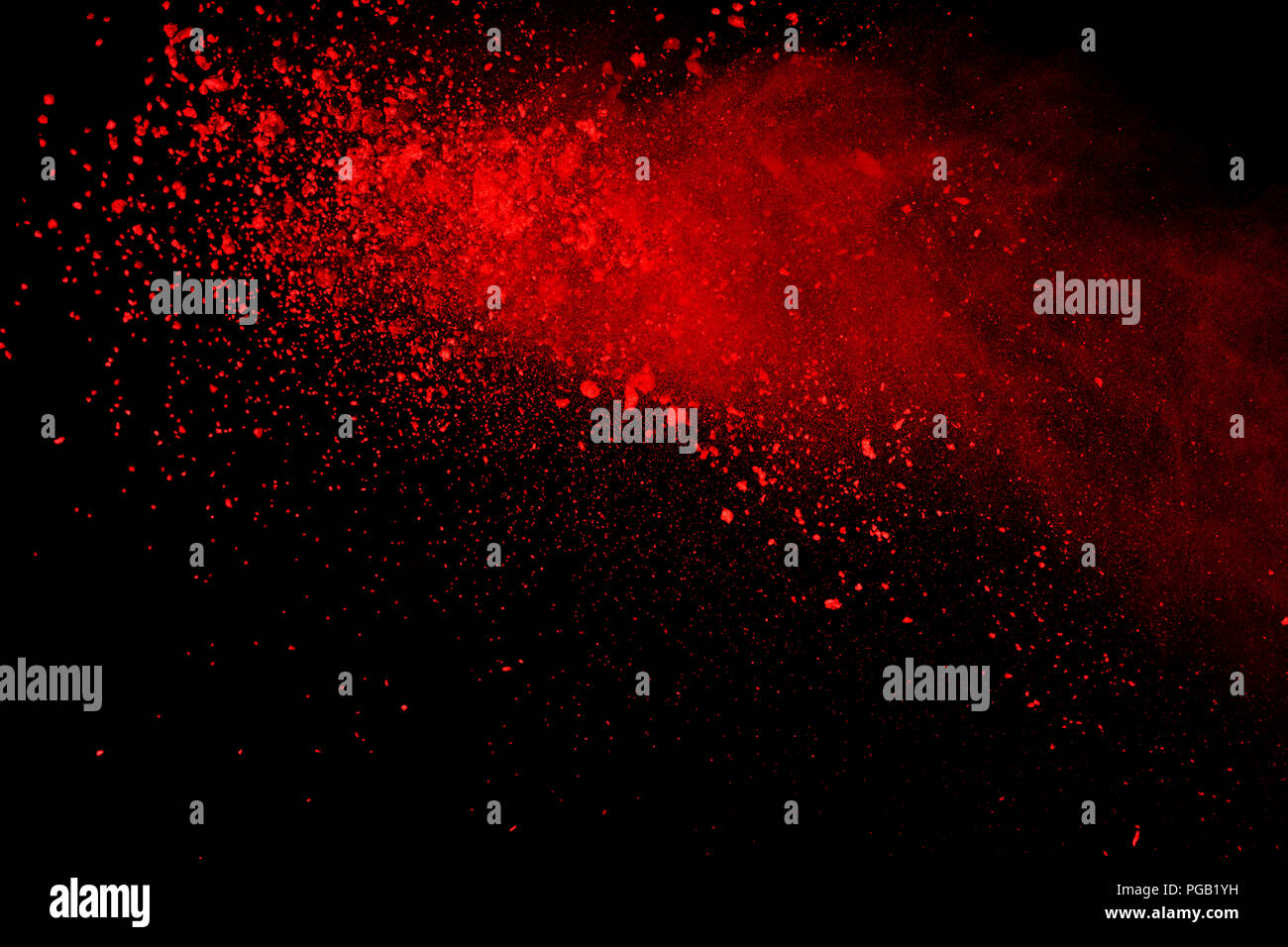 Abstract of red powder explosion on black background. Red powder ...