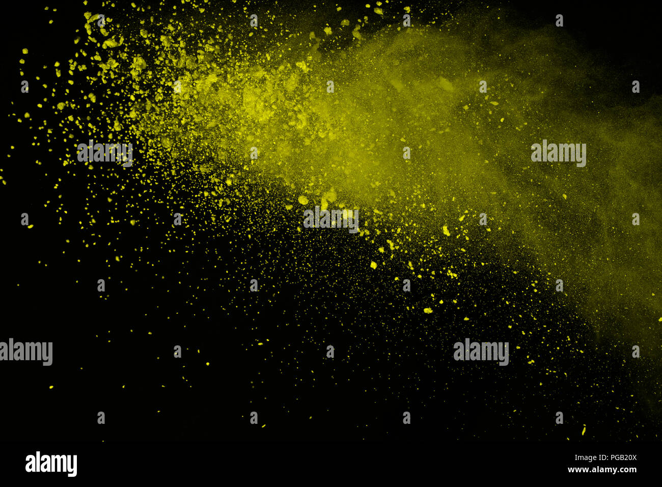 Abstract of yellow powder explosion on black background. Yellow powder ...