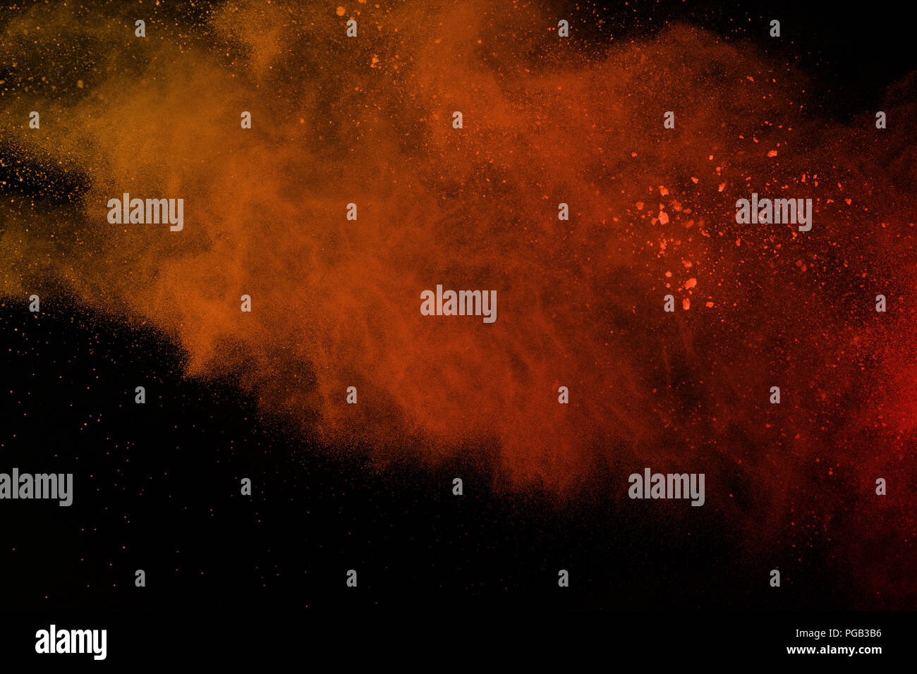 orange powder explosion isolated on black background. Freeze motion of ...