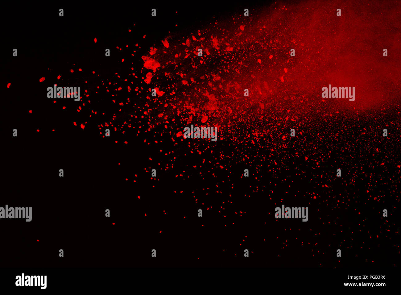 Abstract of red powder explosion on black background. Red powder ...