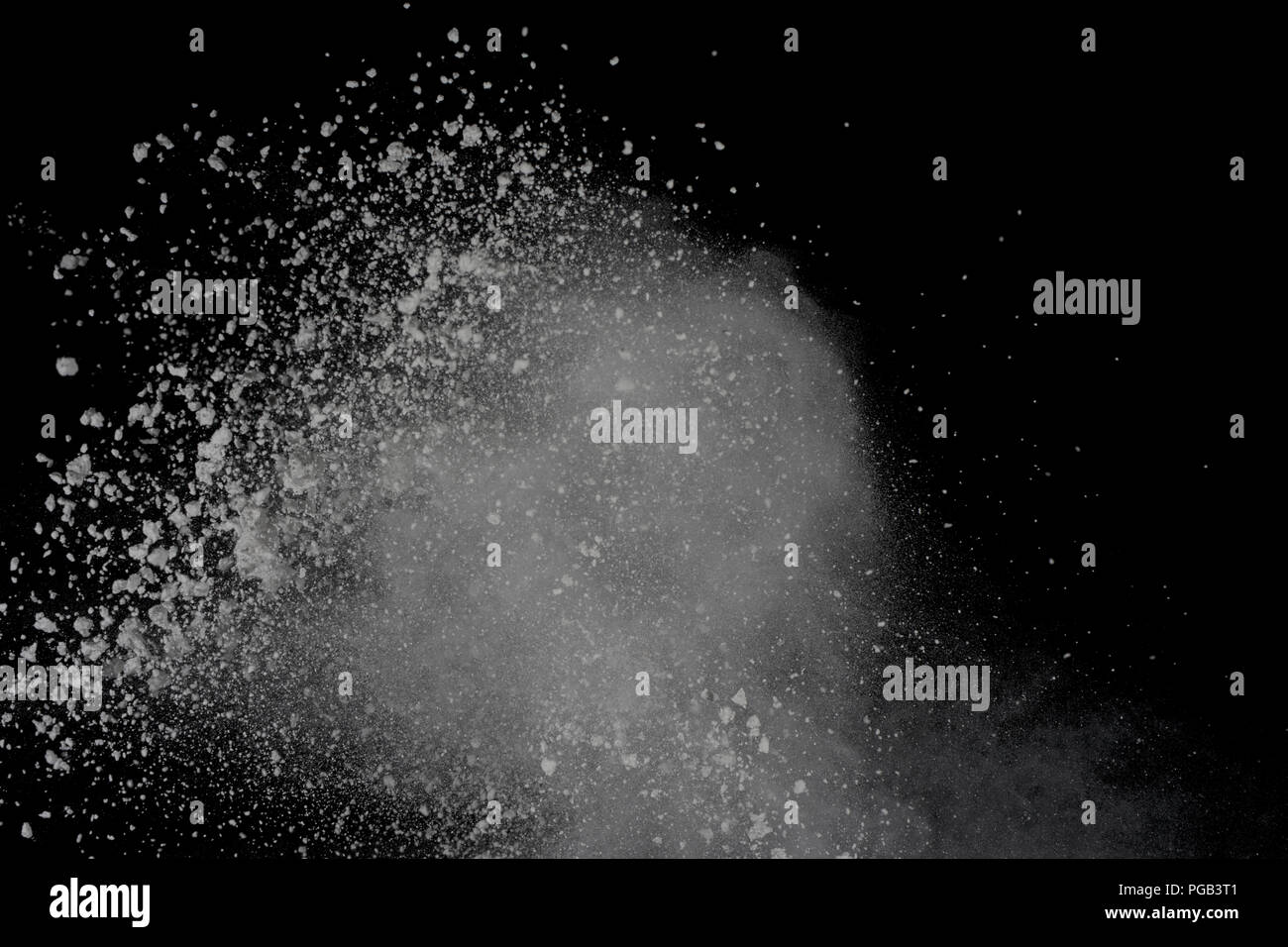 White powder explosion isolated on black background. Colored dust ...