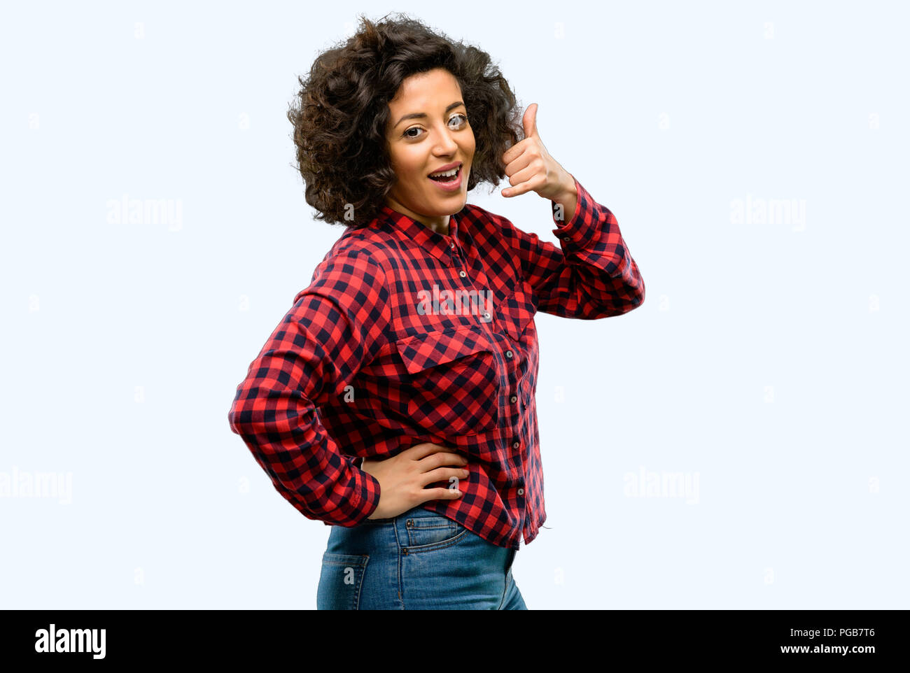 Beautiful arab woman happy and excited making showing call me gesture ...