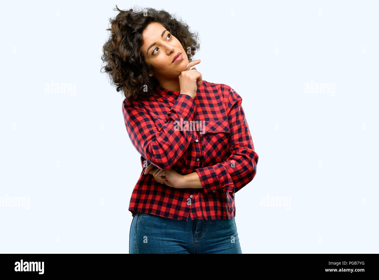 Beautiful arab woman thinking and looking up expressing doubt and ...