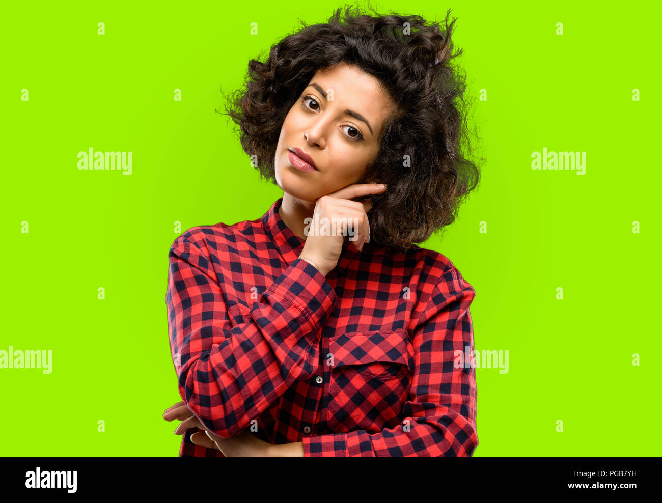 Beautiful arab woman thinking and looking up expressing doubt and ...
