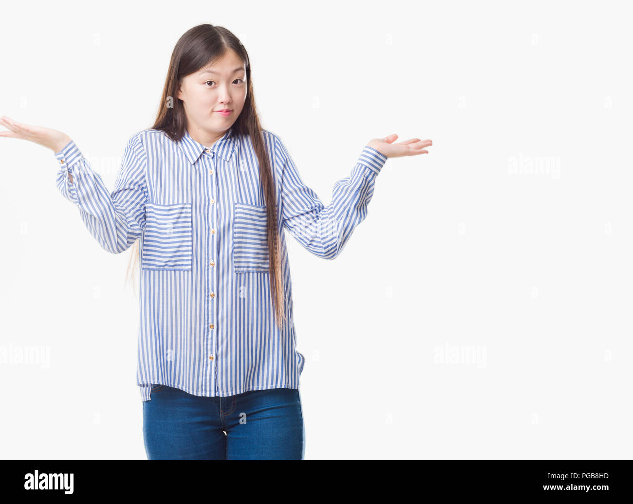 Young Chinese woman over isolated background clueless and confused ...