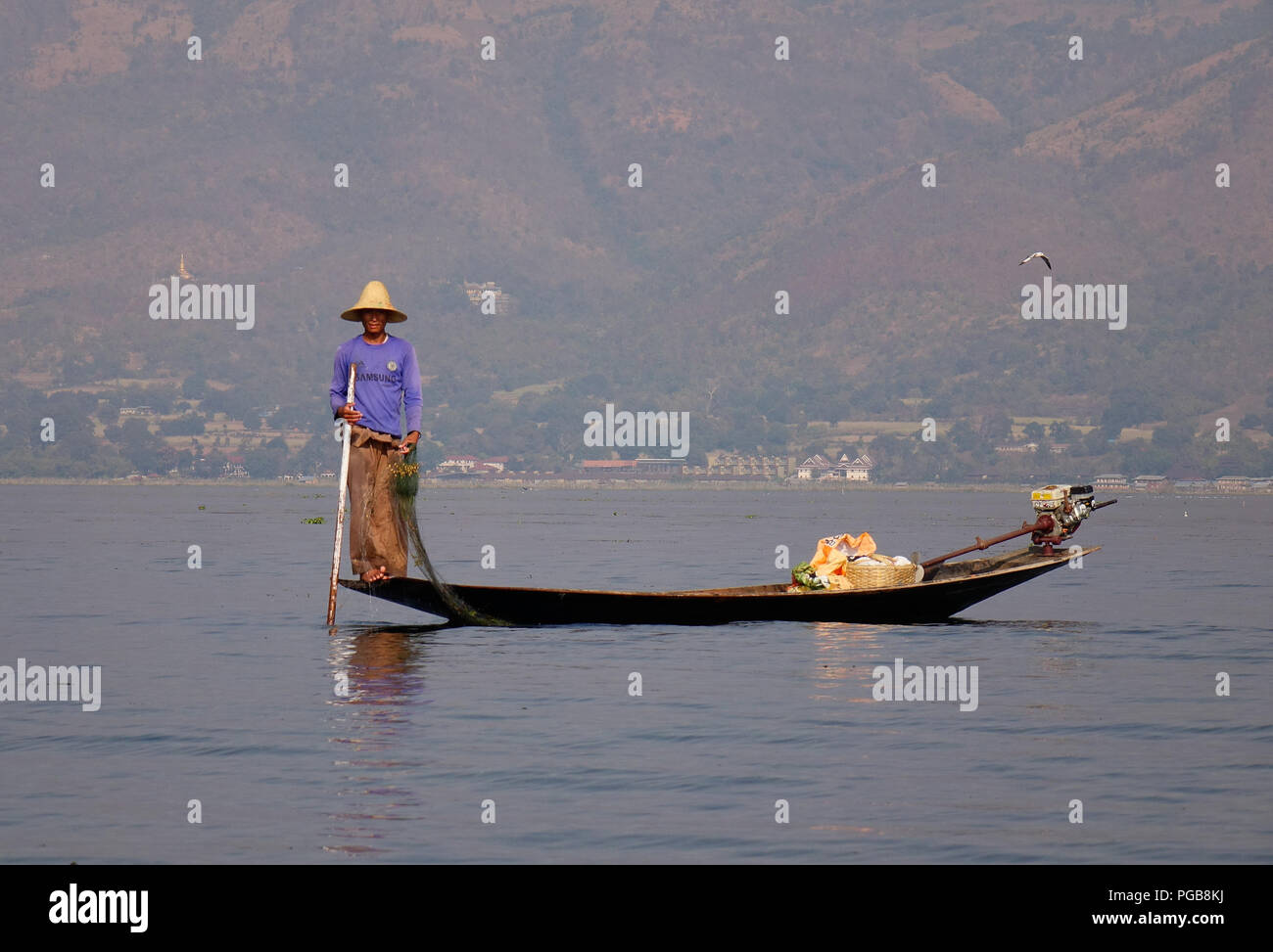 Inle, Myanmar - Feb 14, 2016. Burmese man using the unique methods of ...