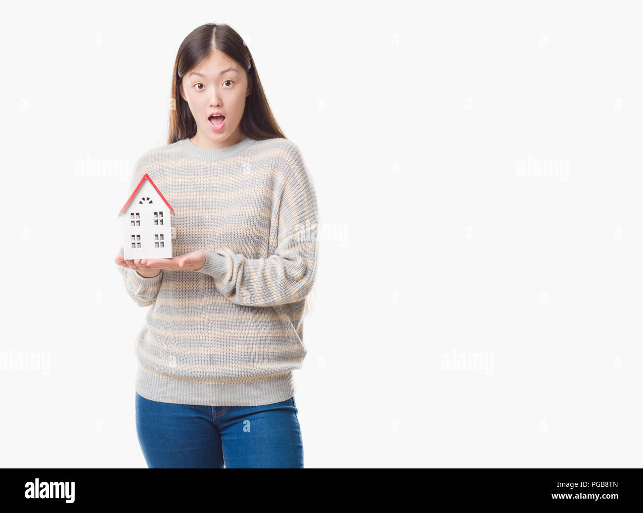Young Chinese real state agent woman over isolated background holding ...