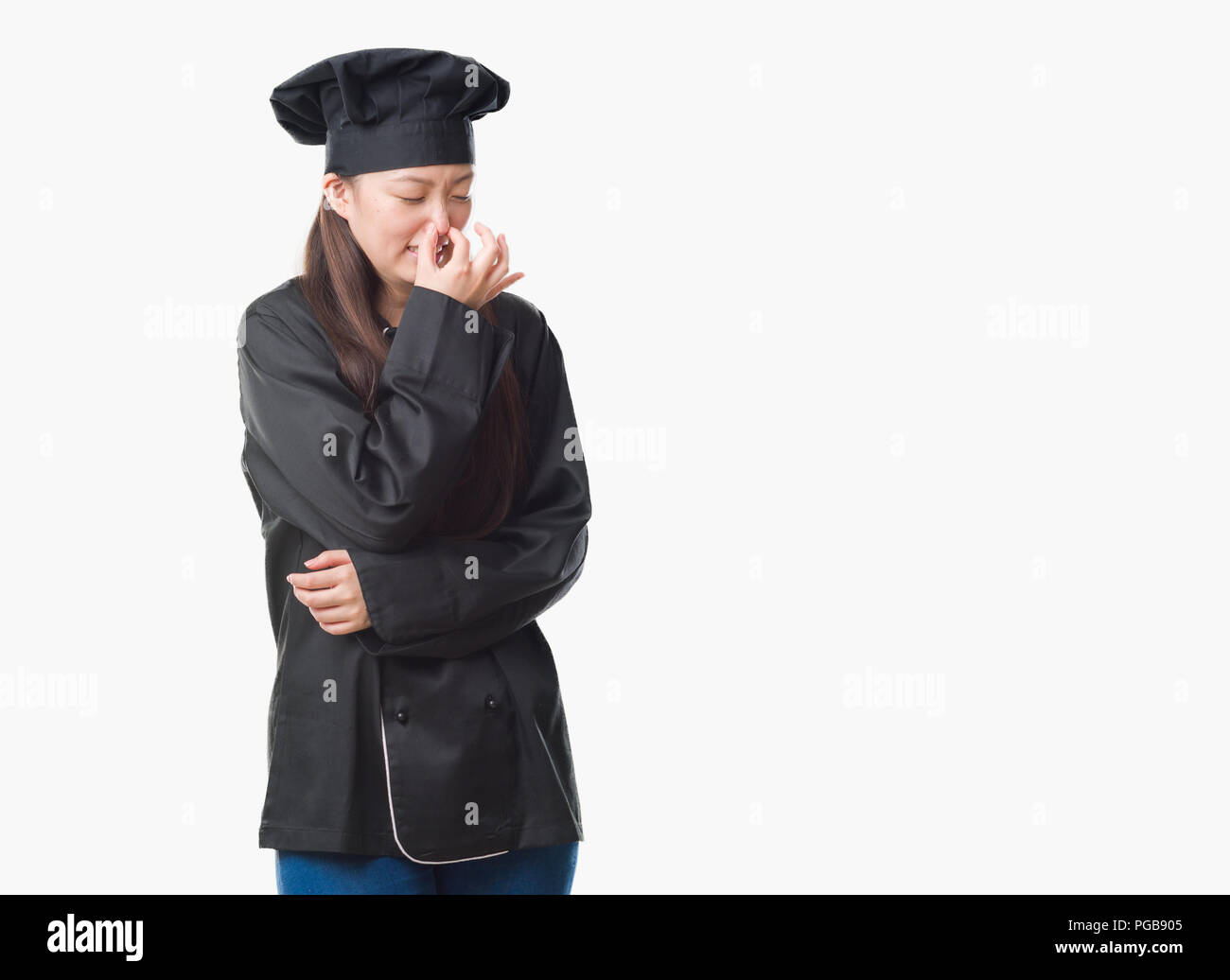 Young Chinese woman over isolated background wearing chef uniform ...
