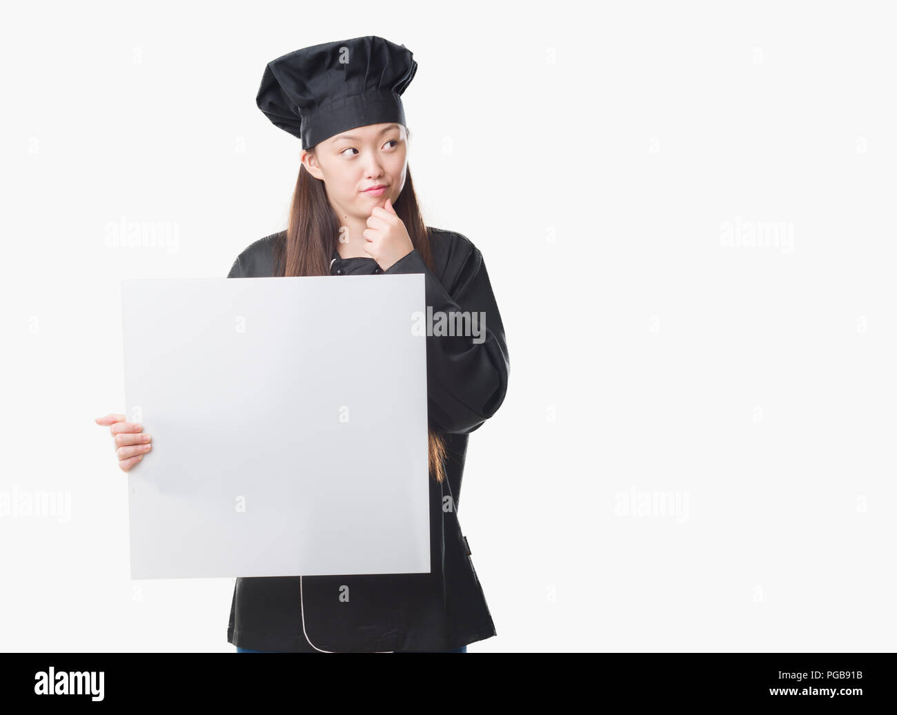 Young Chinese woman over isolated background wearing chef uniform ...