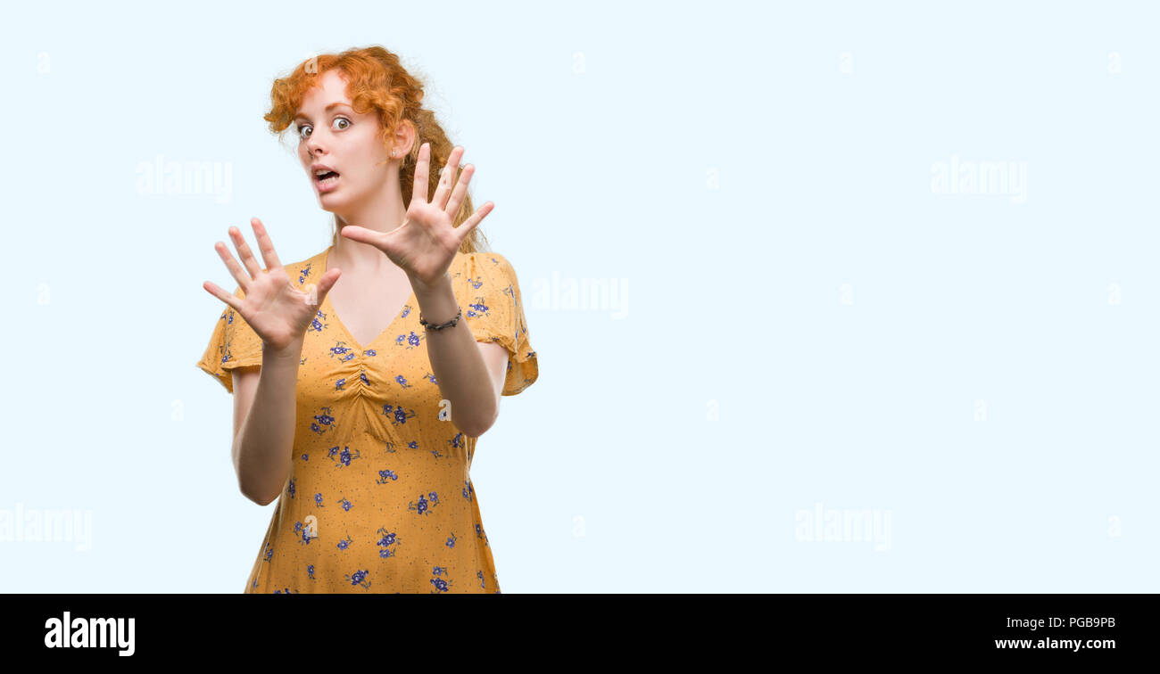 Young redhead woman afraid and terrified with fear expression stop ...