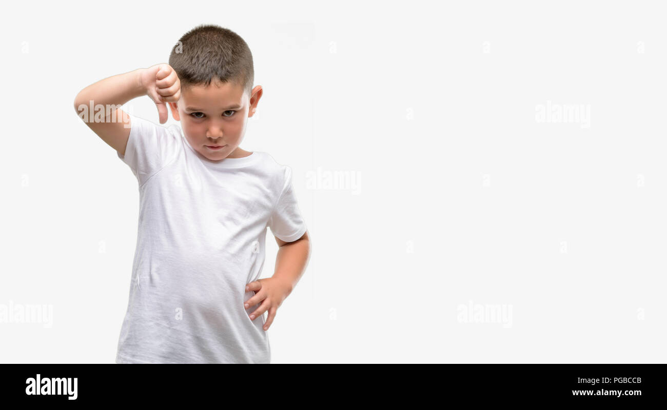 Dark haired little child with angry face, negative sign showing dislike ...