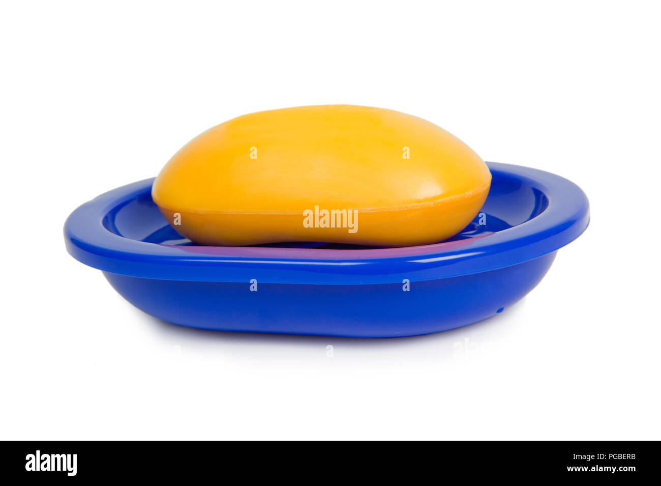 Soap of yellow color in a dark blue soap tray, is isolated on a white ...